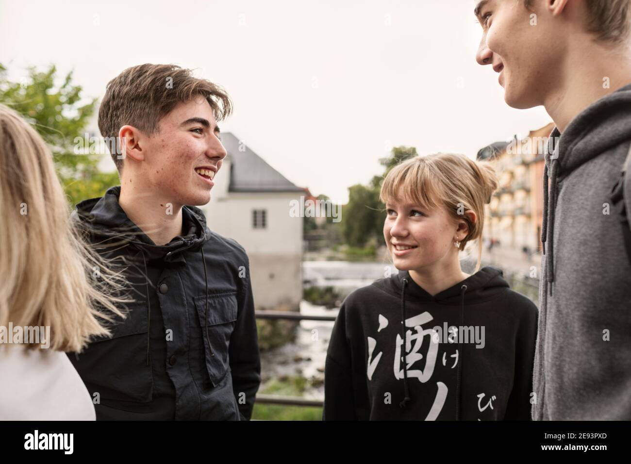 Smiling teenagers talking Stock Photo - Alamy