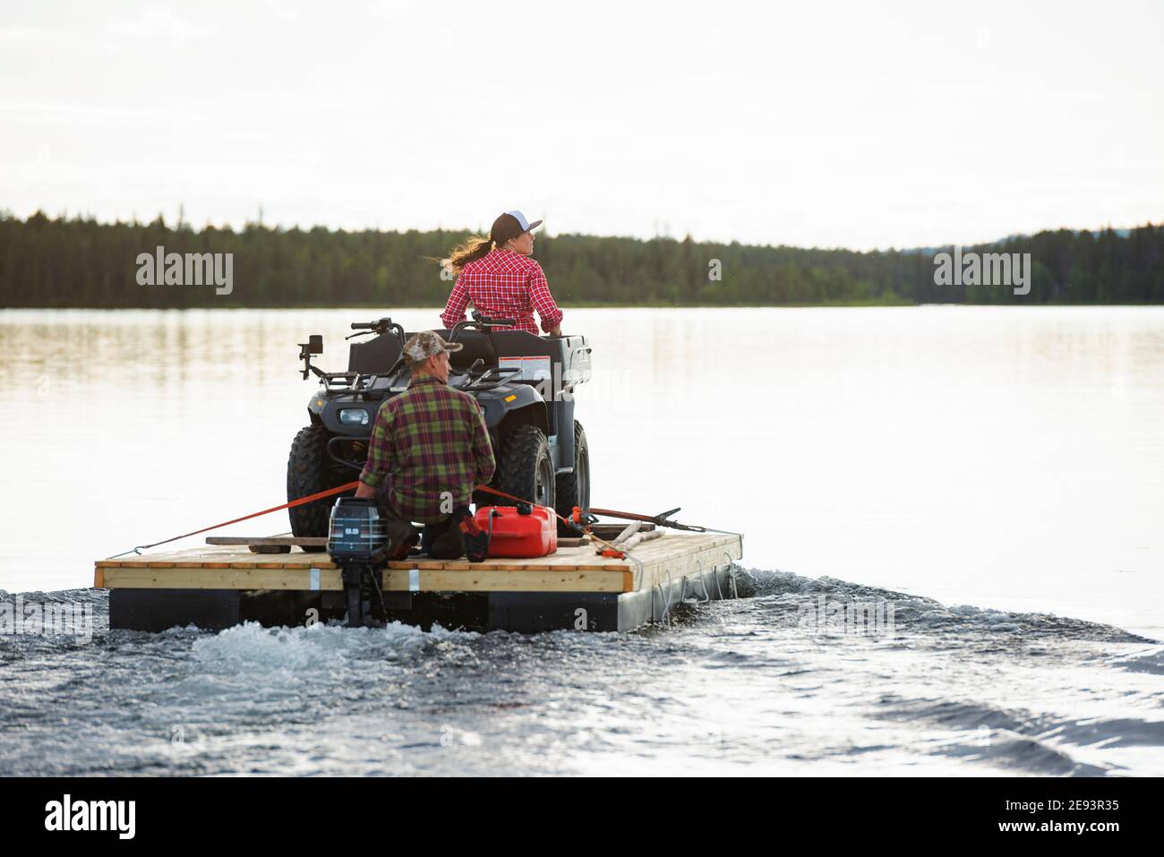 Couple transporting quadbike on motor raft Stock Photo - Alamy