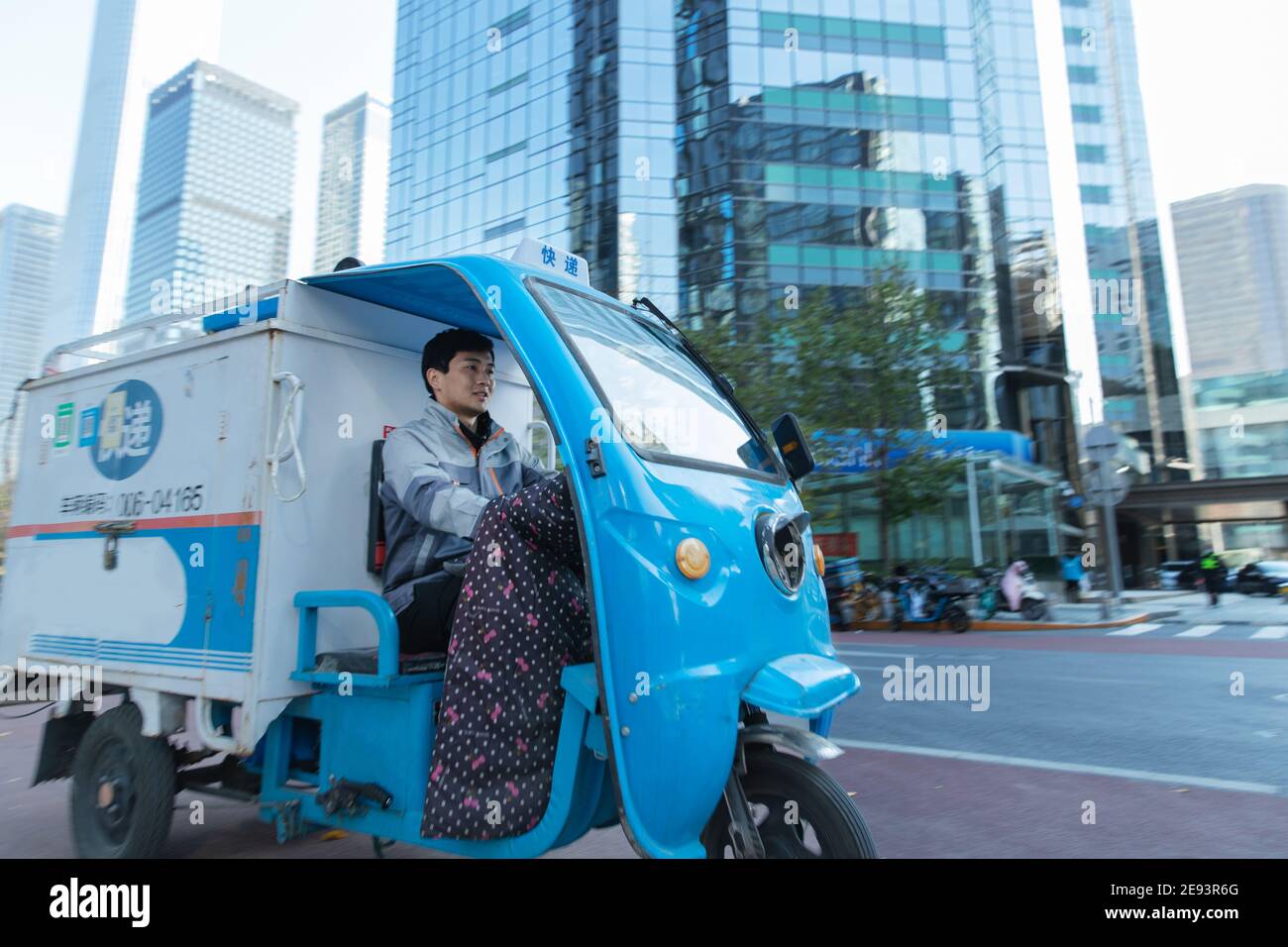 Work on the way driving tricycle Courier Stock Photo - Alamy