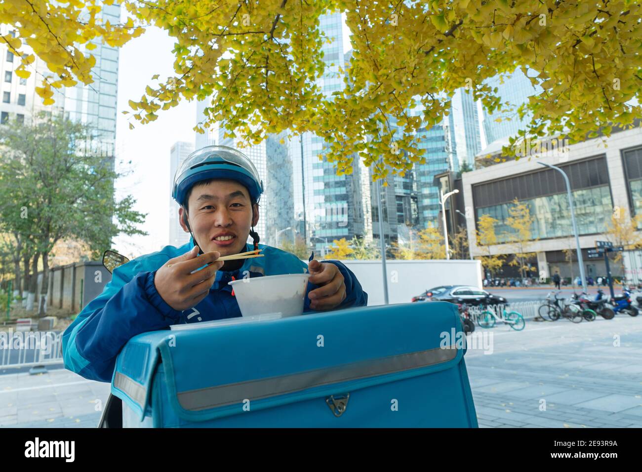 Take-away member in the street to eat to have a rest Stock Photo - Alamy