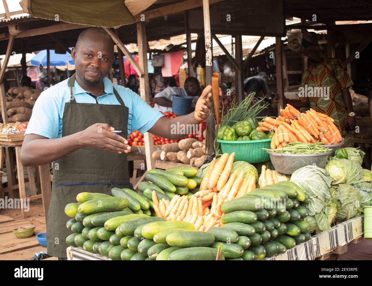 Black man selling vegetables hi-res stock photography and images - Alamy