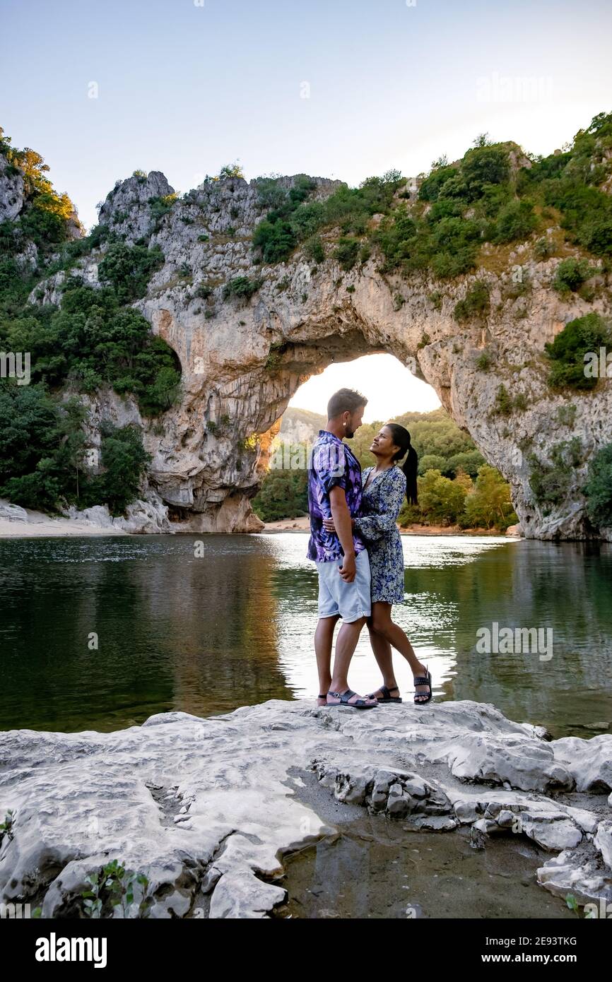 couple men and woman visiting The famous natural bridge of Pont d'Arc ...