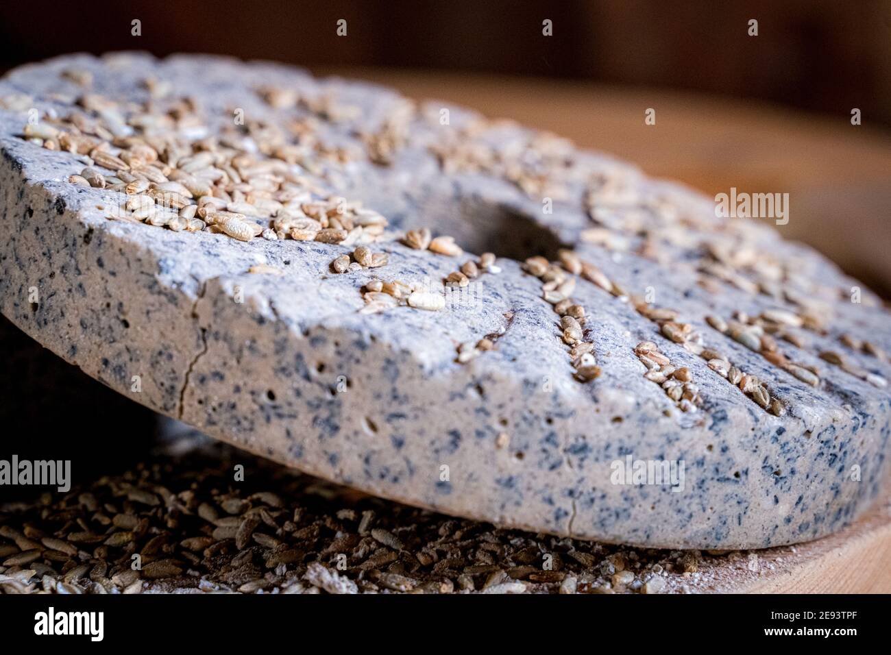 Old technique of manufacturing flour with an ancient grinding millstone ...