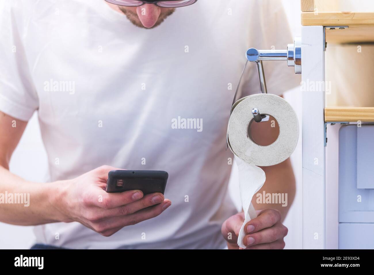Man sitting on toilet using hi-res stock photography and images - Alamy