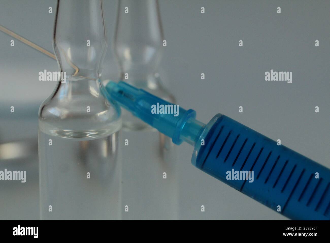 vaccination vaccination syringe with blue medicine liquid and vials ...