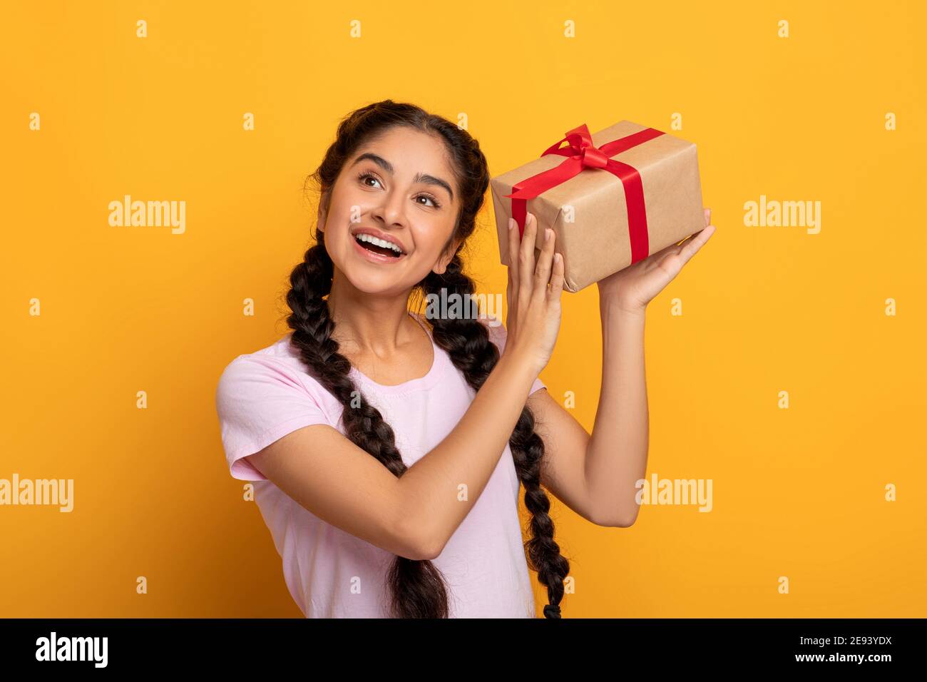 Woman shaking gift box hi-res stock photography and images - Alamy