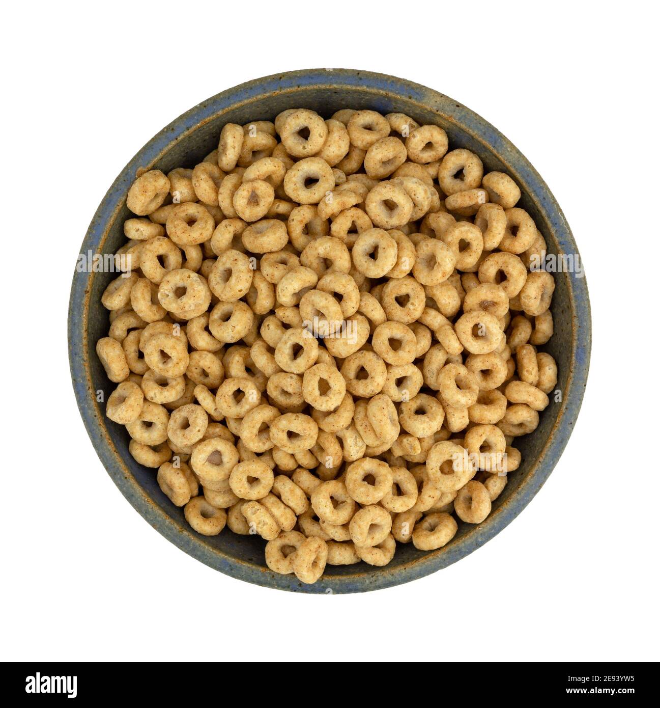 Top view of dry generic round whole grain oat cereal in an old blue ...