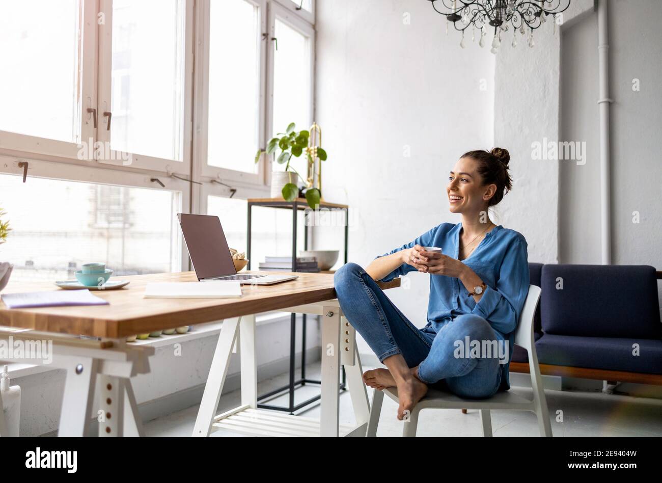 Portrait of a smiling creative woman in a modern loft space Stock Photo ...