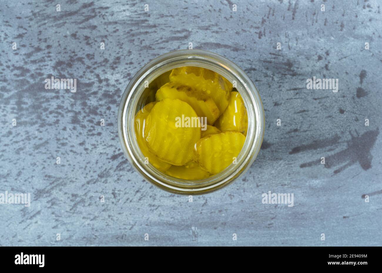 Top view of an opened glass jar filled with hamburger dill pickle ...