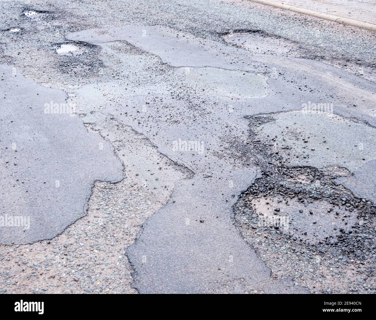 Road damage in the potholes from frost in winter Stock Photo - Alamy
