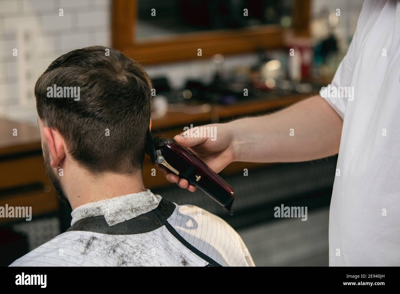 Delighted. Close up of client of master barber, stylist during getting ...