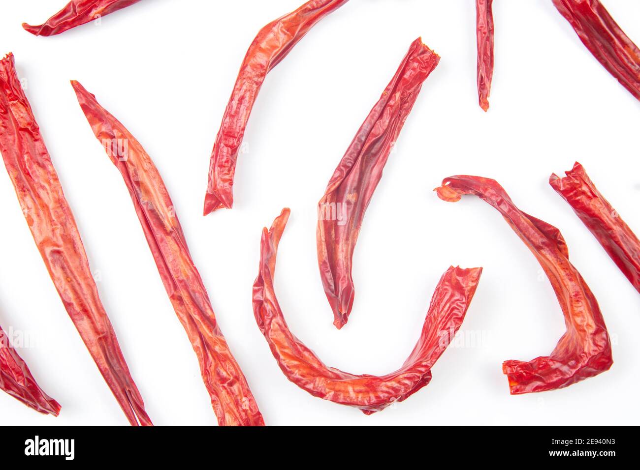 red dried hot peppers on white background Stock Photo - Alamy