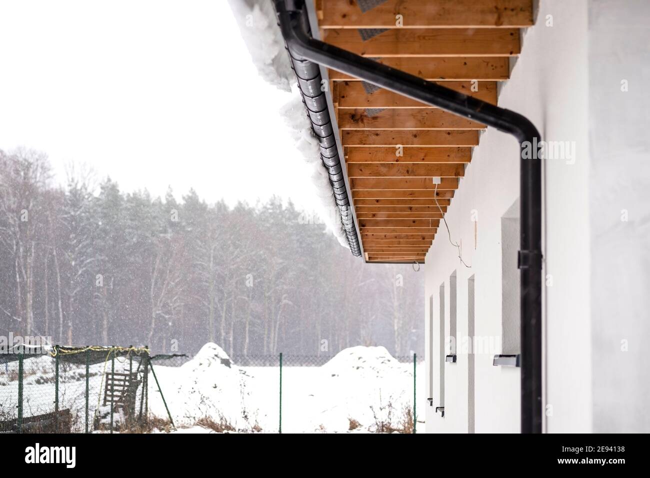 The roof of a single-family house is covered with snow, visible roof ...