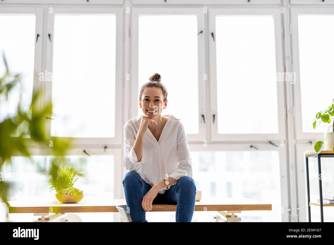 Portrait of a smiling creative woman in a modern loft space Stock Photo ...