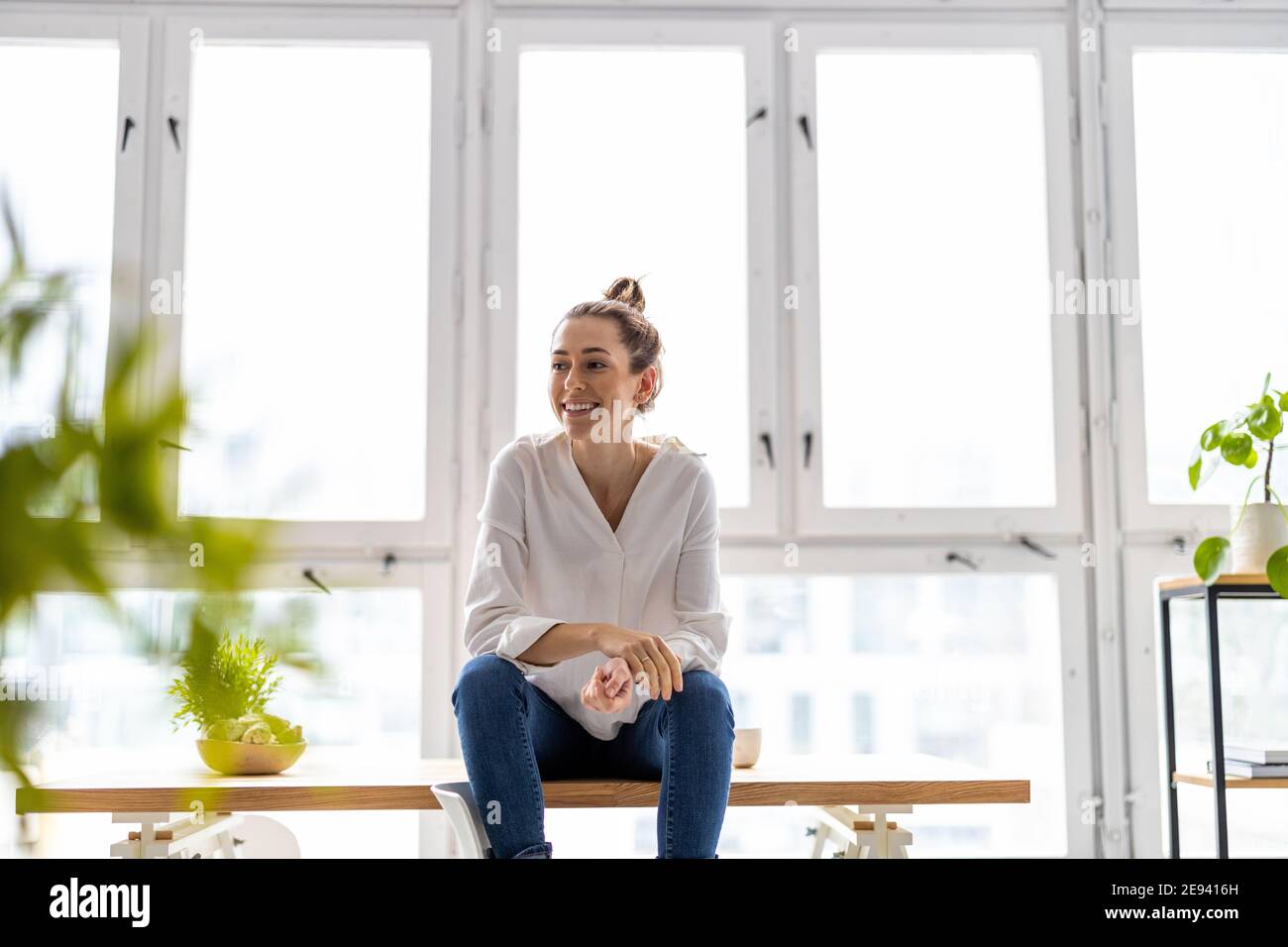 Portrait of a smiling creative woman in a modern loft space Stock Photo ...