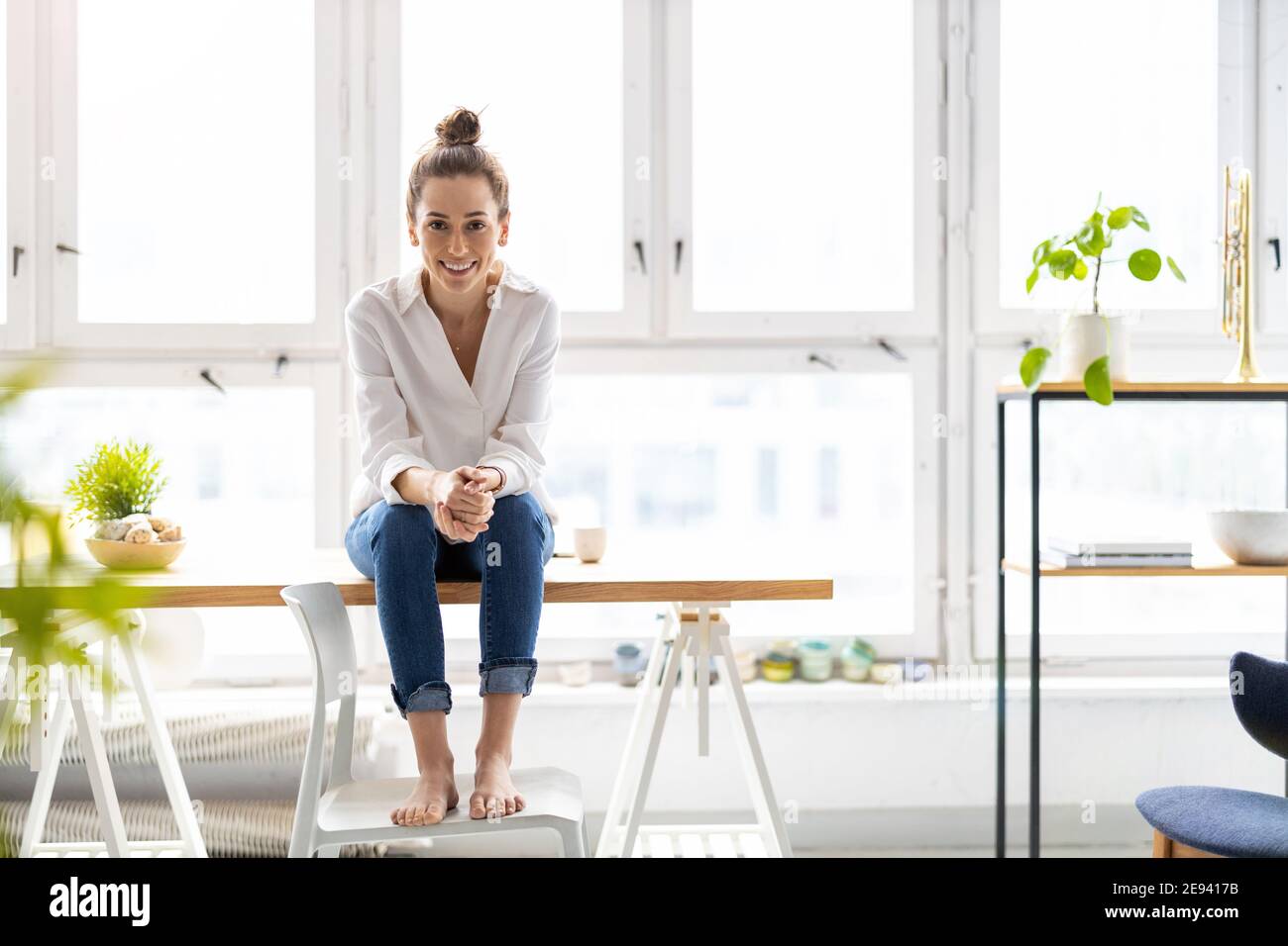 Portrait of a smiling creative woman in a modern loft space Stock Photo ...