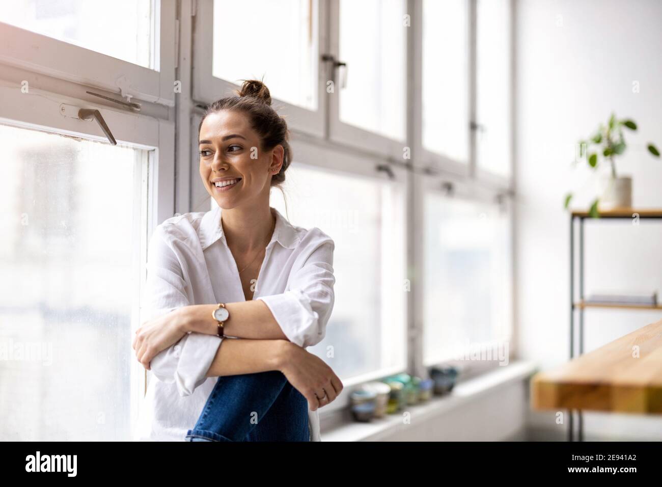 Portrait of a smiling creative woman in a modern loft space Stock Photo ...