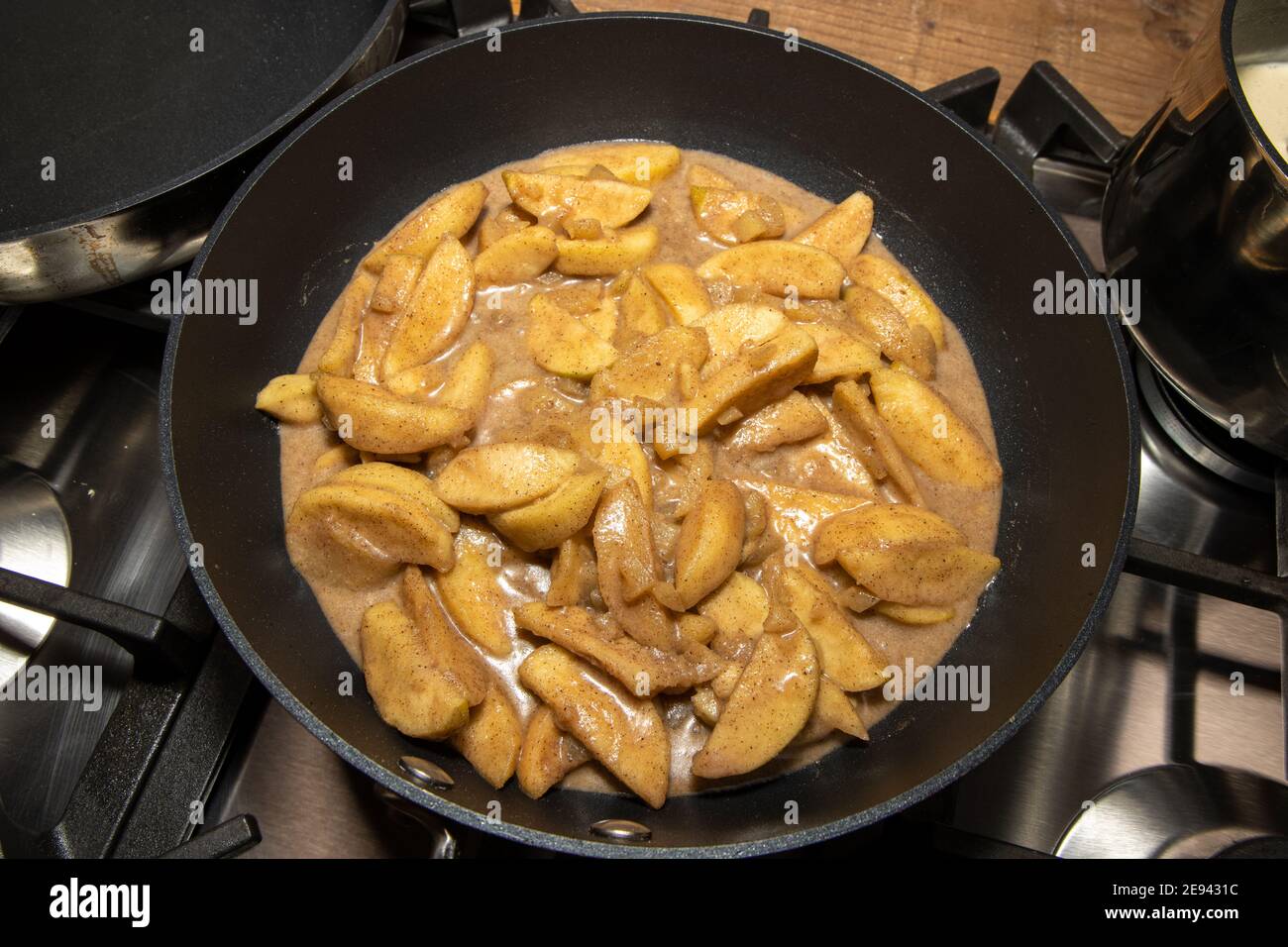 A pan full of sliced spiced cooking apples ready to be put in a ...