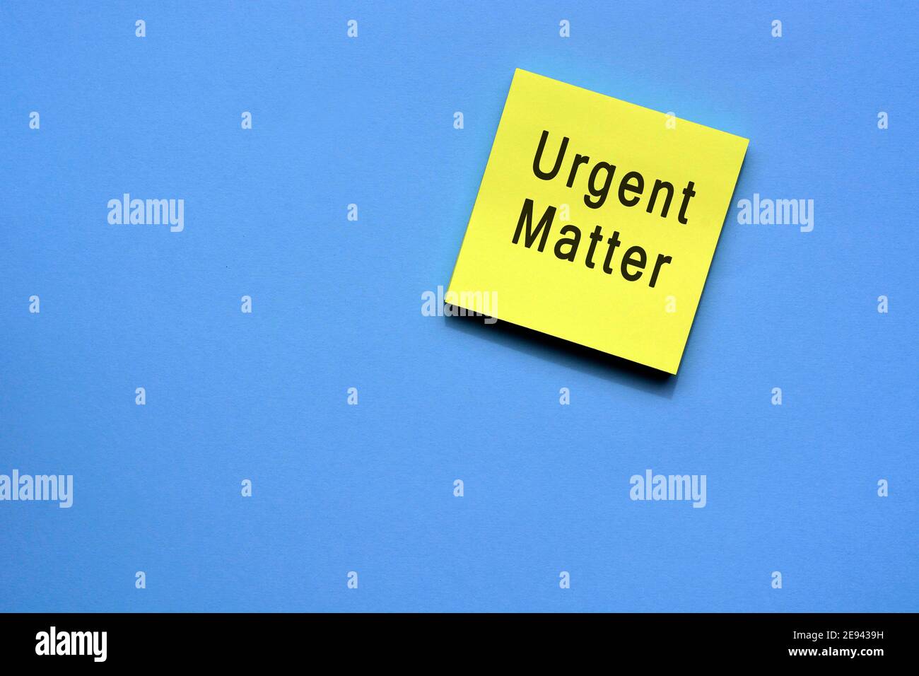 Urgent matter text on yellow sticky note with blue background Stock ...