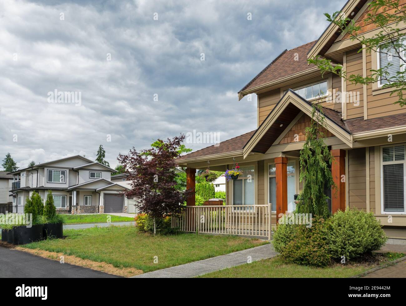 Street view in suburban residential area on cloudy sky background Stock ...