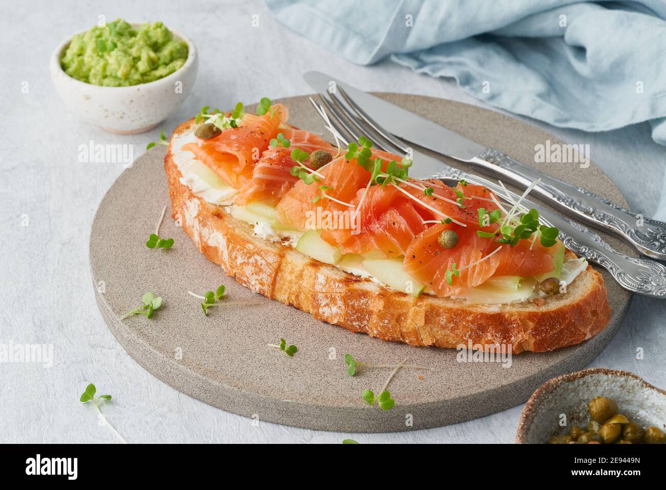 Two open sandwich, toast with salmon, cream cheese, avocado, cucumber ...