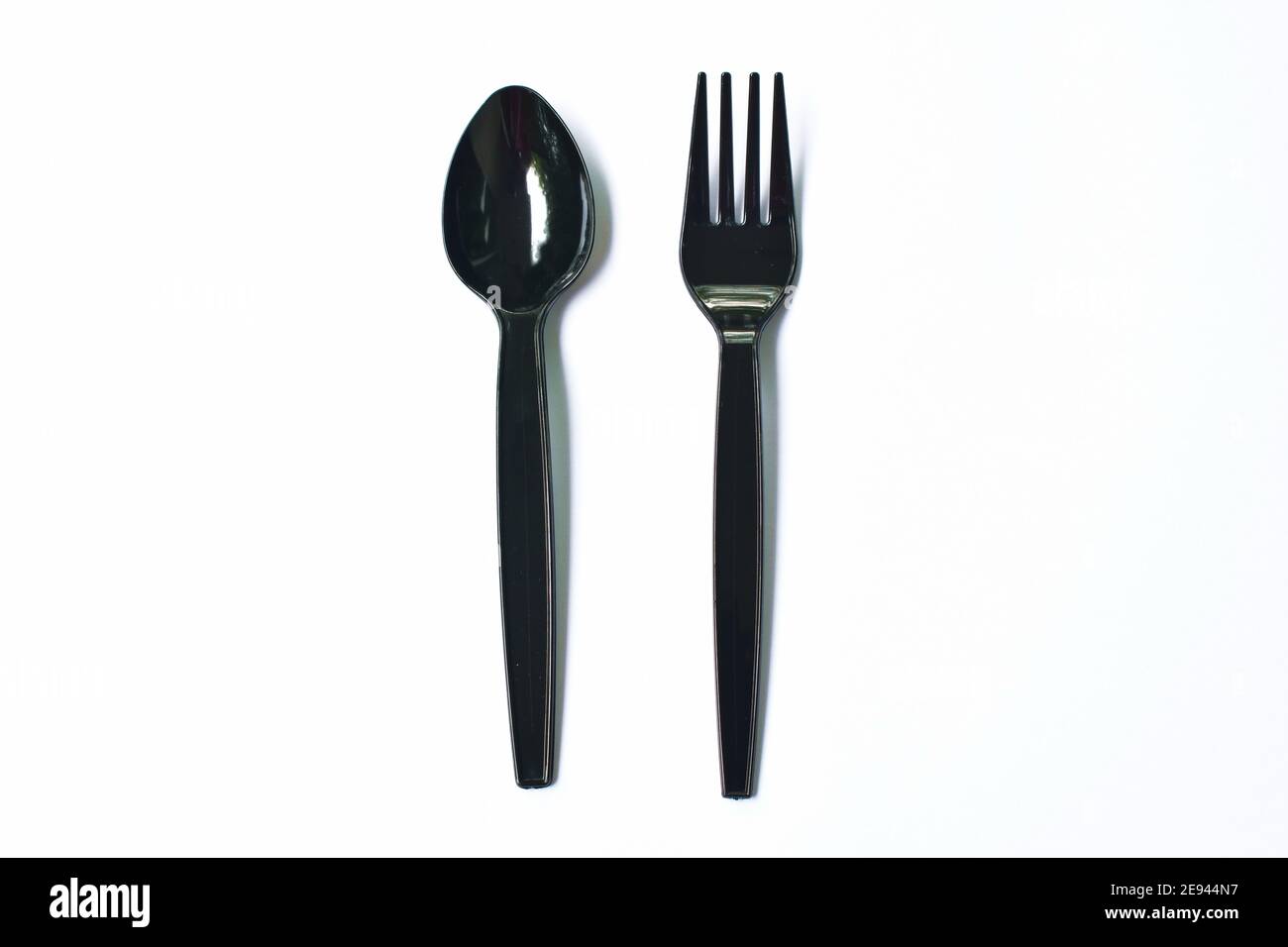 black plastic spoon and fork for single used on white background Stock ...