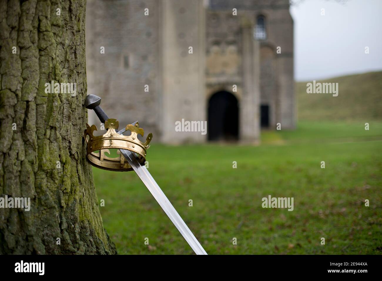 Crown and sword rest against tree outside castle keep Stock Photo - Alamy