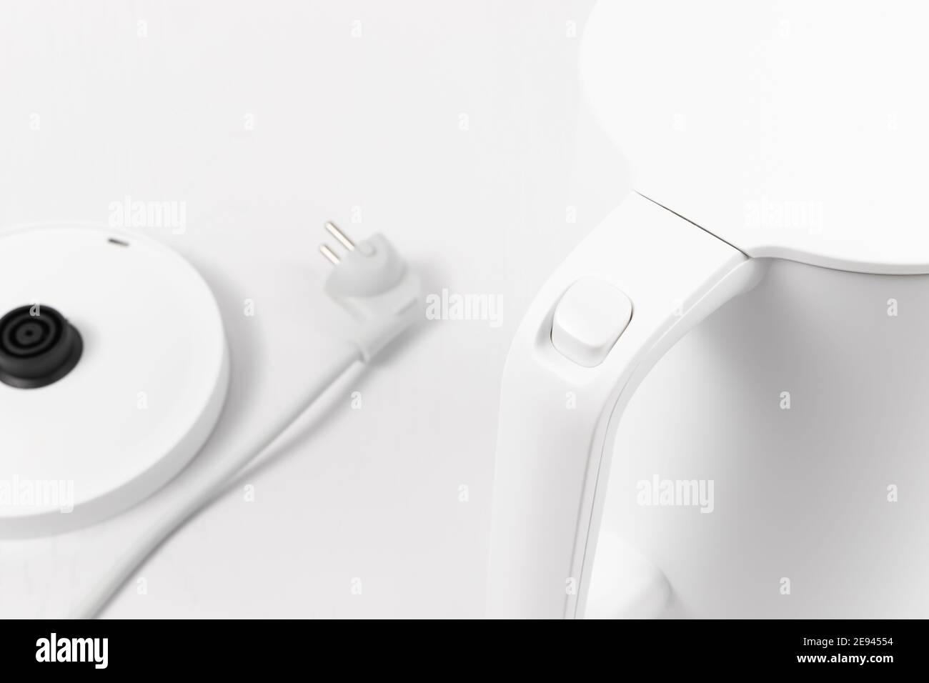 white electric kettle with lid lift button and switch on white ...