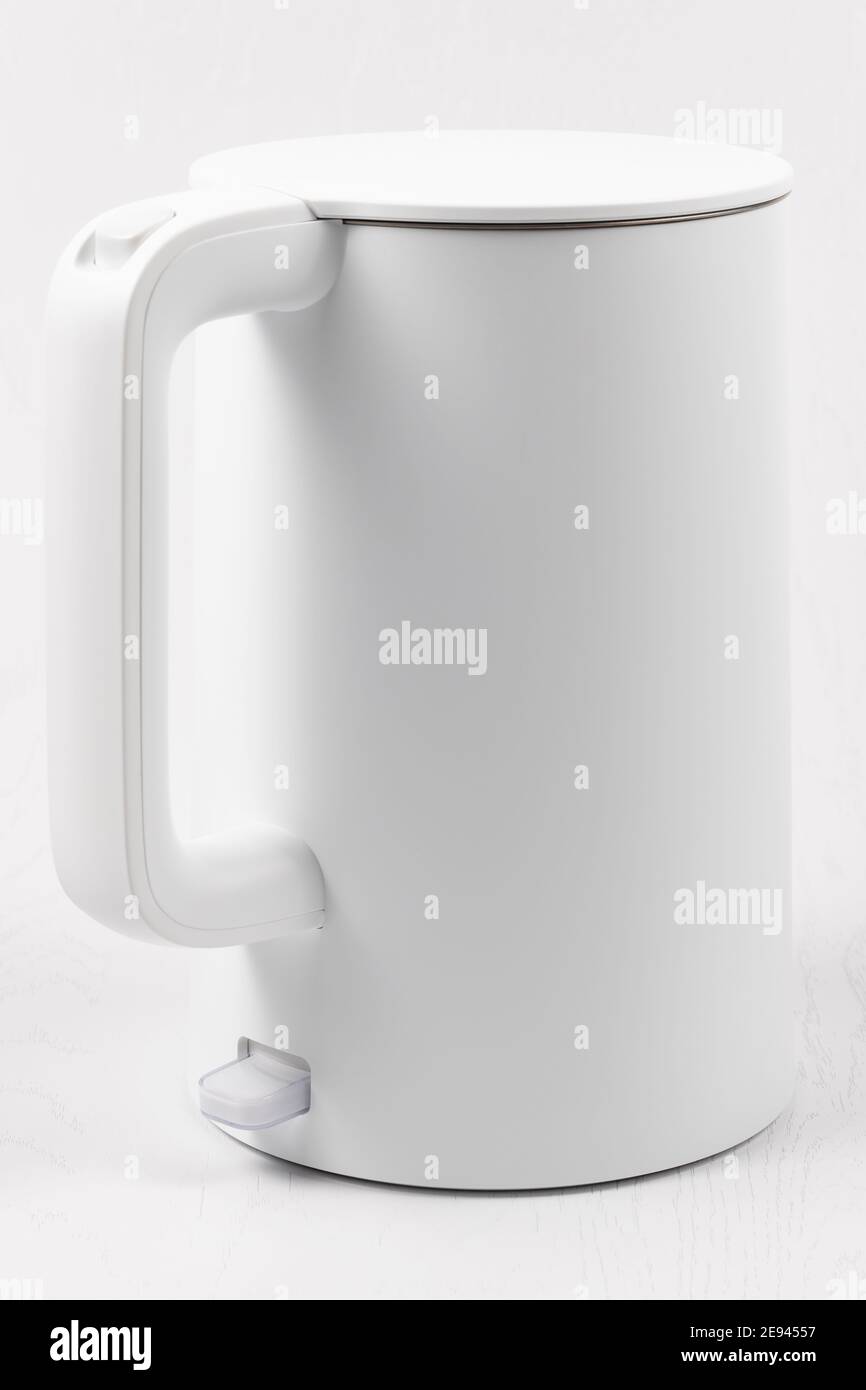 white electric kettle with lid lift button and switch on white ...