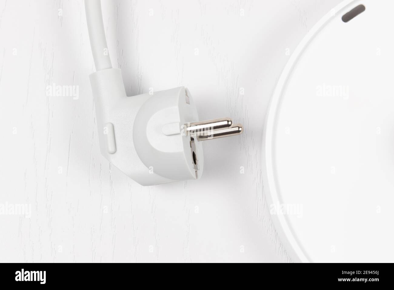 white teapot stand with wire and electric plug on white wooden table ...