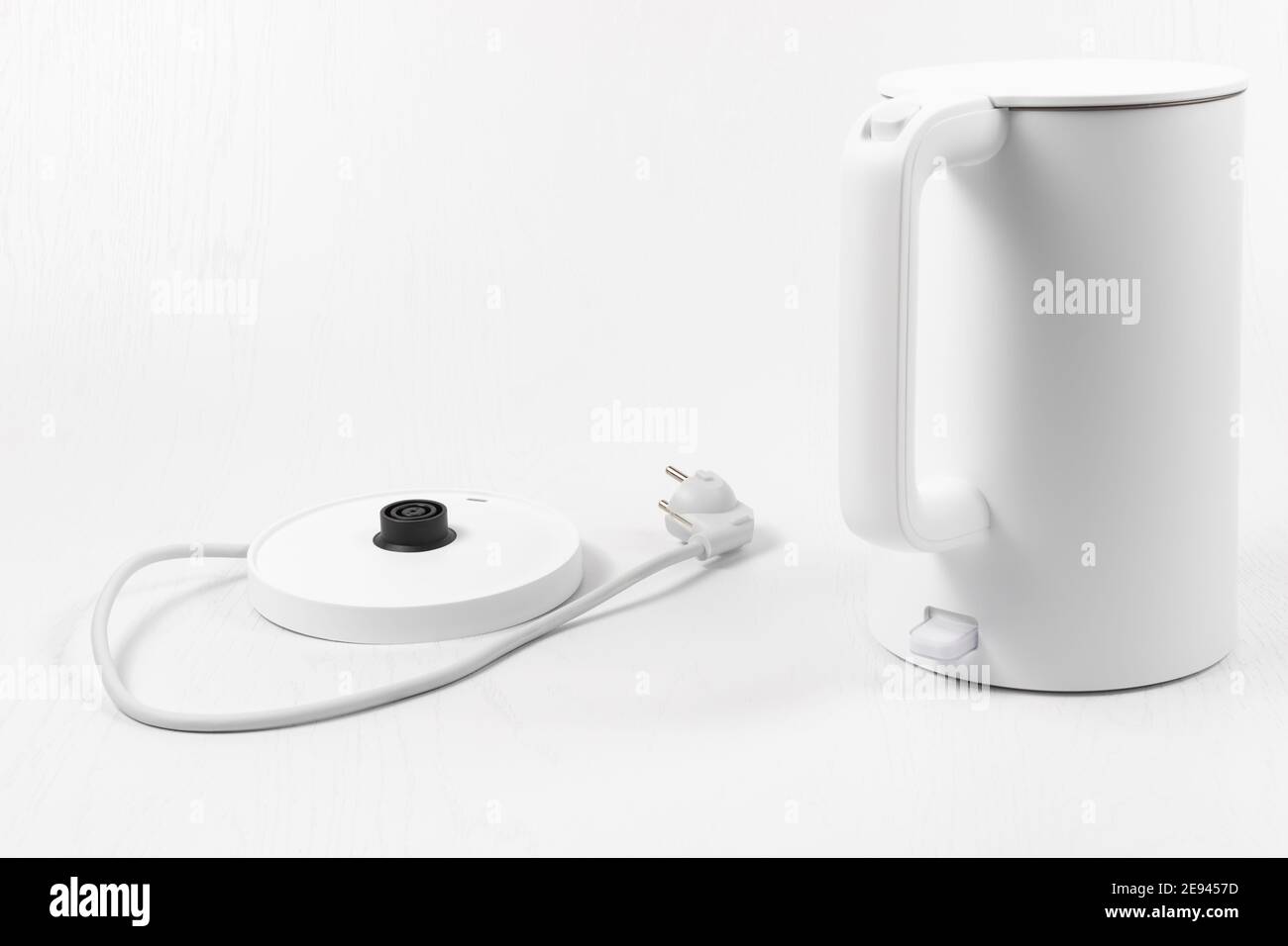 white electric kettle with lid lift button and switch on white ...
