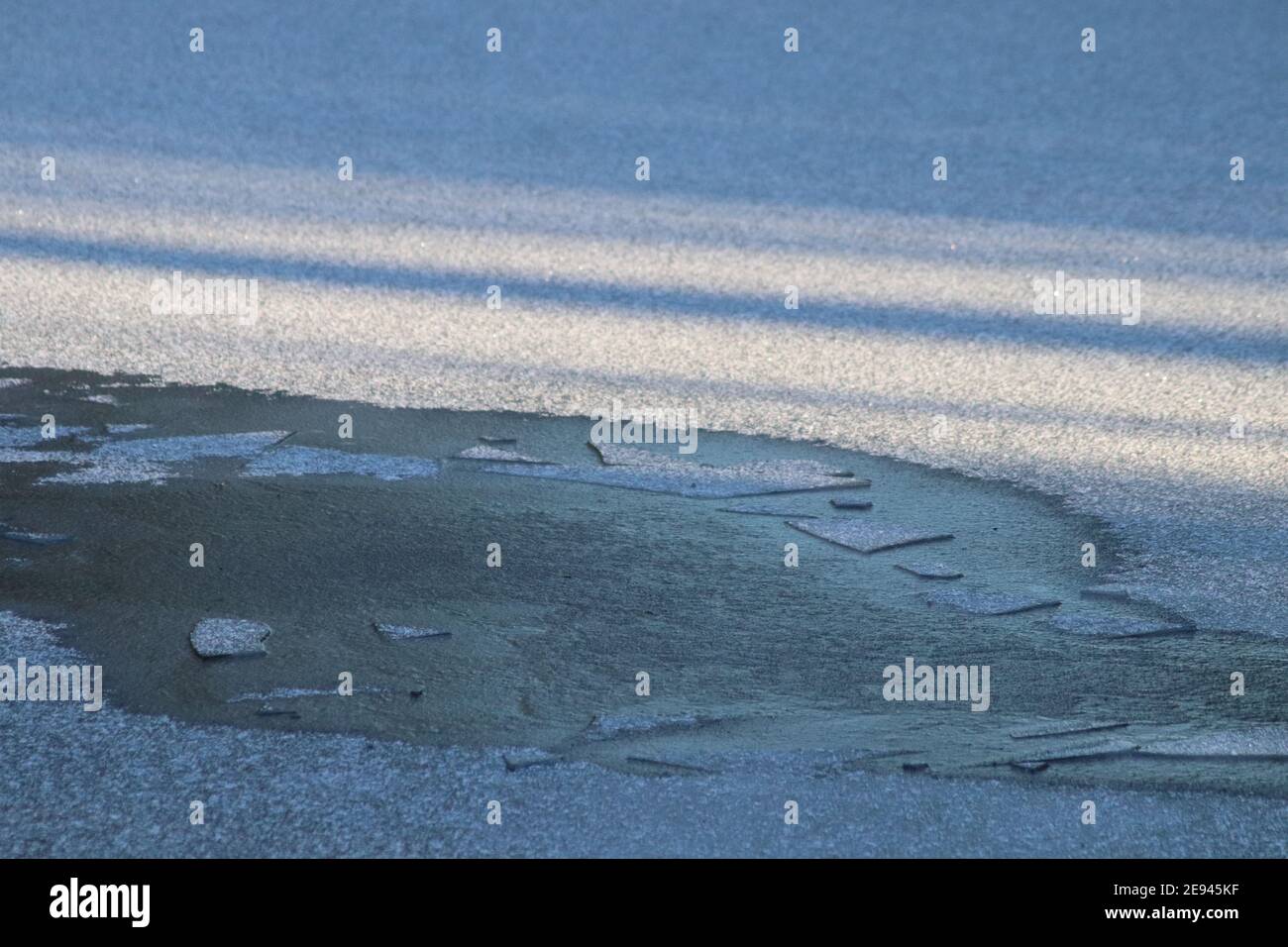Fragments of ice in frozen lake Stock Photo - Alamy
