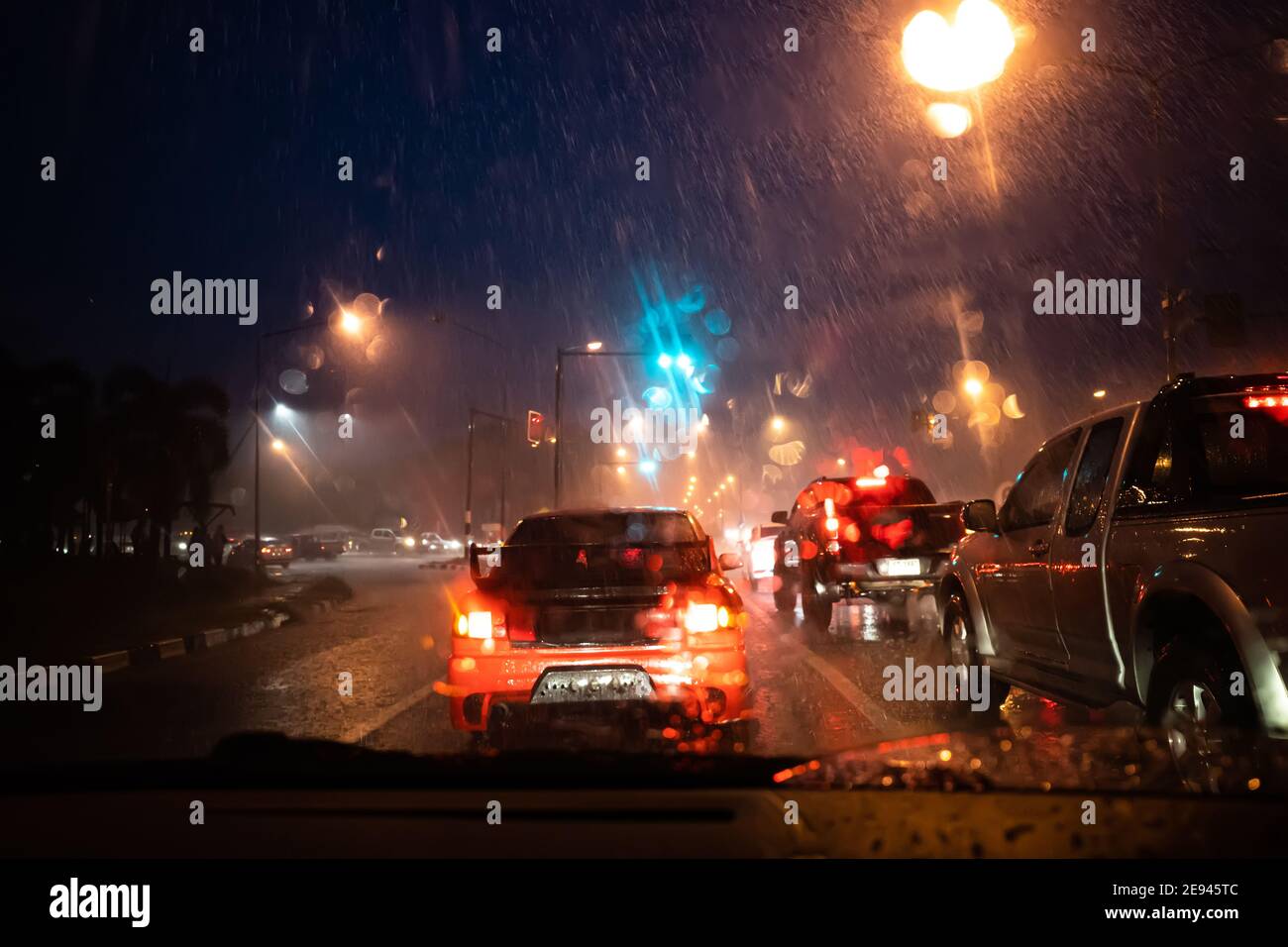 Cars driving through rainy at night Stock Photo - Alamy
