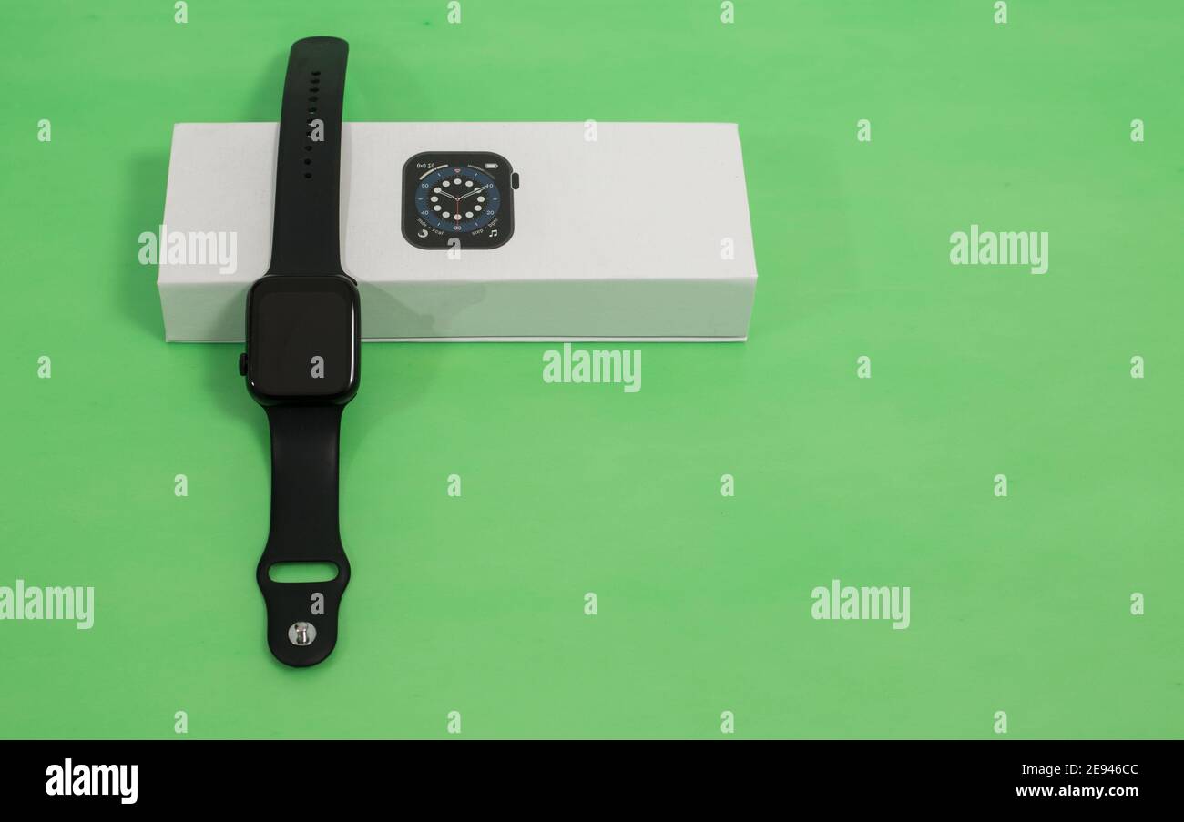Smartwatch and a box isolated on green background Stock Photo - Alamy