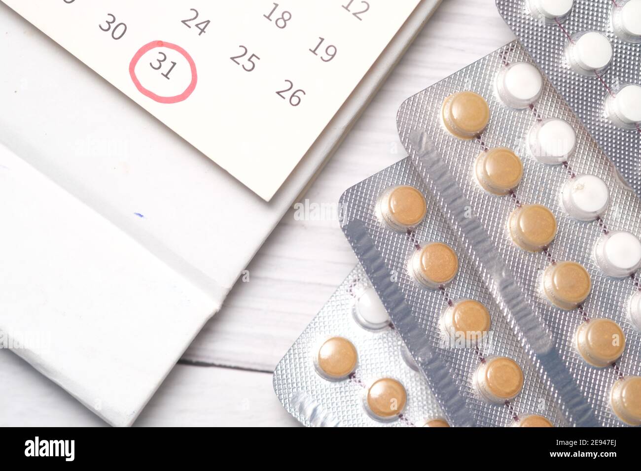 birth control pills , calendar and notepad on table Stock Photo - Alamy