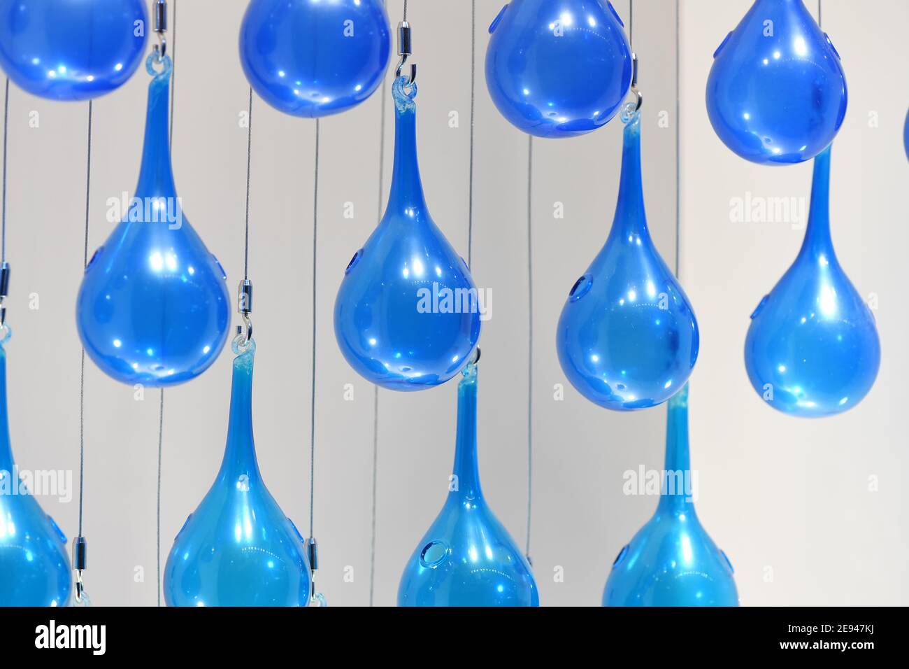 Blue glass bubble decoration tied rope hanging on ceiling Stock Photo ...