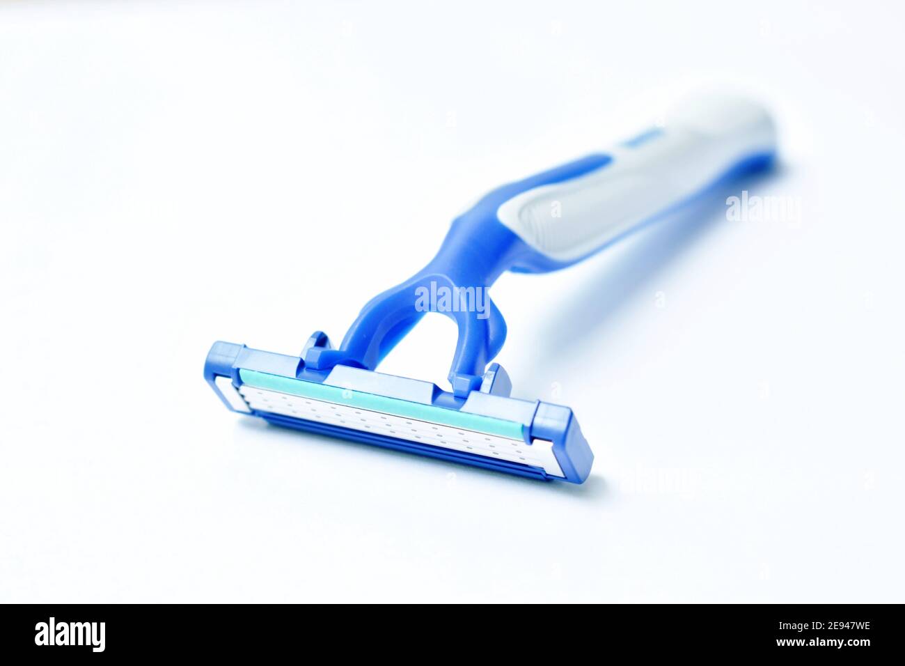 blue plastic shaver arranging on white background Stock Photo - Alamy