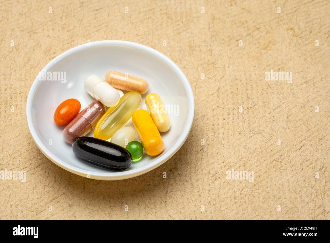 vitamins and supplements - pills, capsules and tablets in a small bowl ...