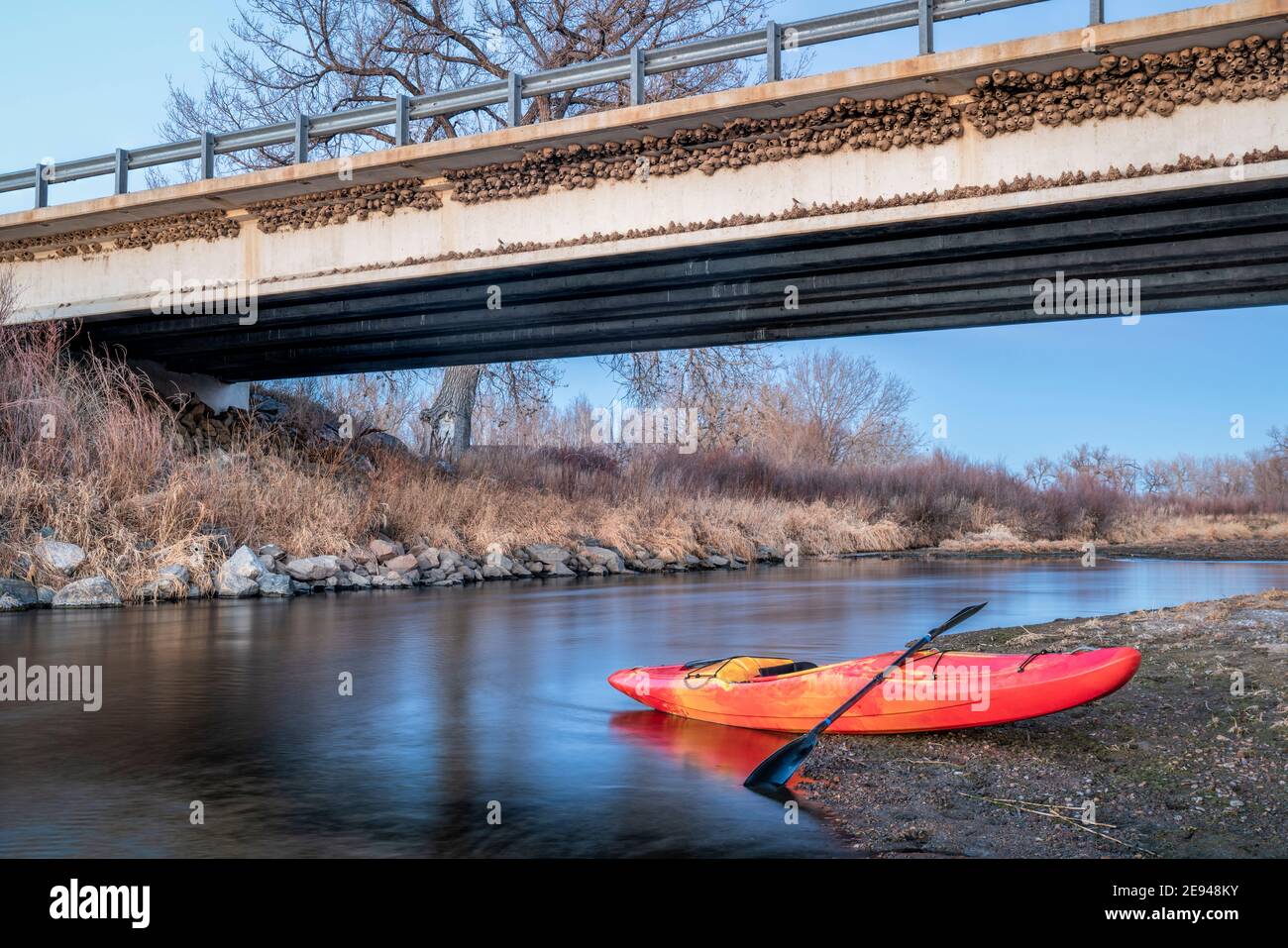 winter kayaking in Colorado - red whitewater kayak on shore of St Vrain ...