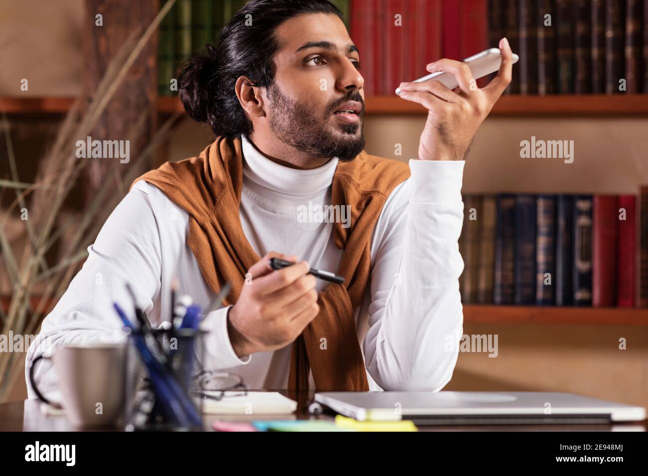 Indian Student Guy Using Voice Assistant On Smartphone Sitting Indoors ...