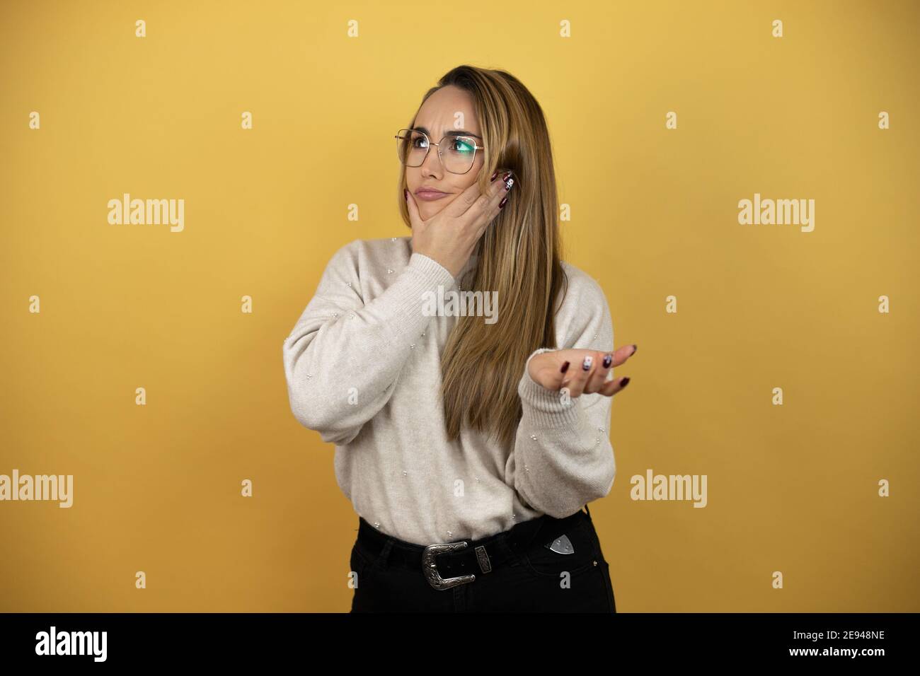 Pretty woman with long hair thinking looking tired and bored with ...