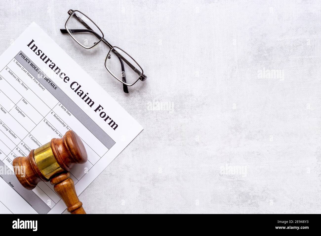 Insurance claim form with judge gavel . Top view Stock Photo - Alamy