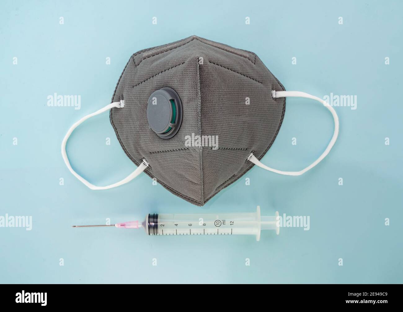 Respiratory protection mask next to the syringe,Health care and medical ...