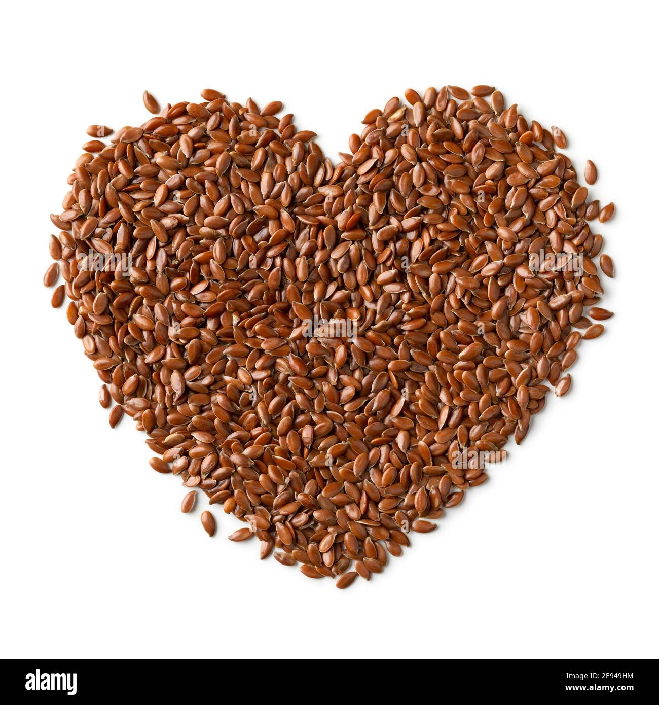 Raw whole linseed in heart shape isolated on white background Stock Photo - Alamy