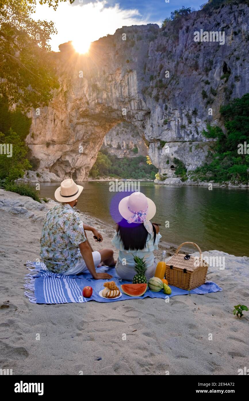 couple men and woman visiting The famous natural bridge of Pont d'Arc ...