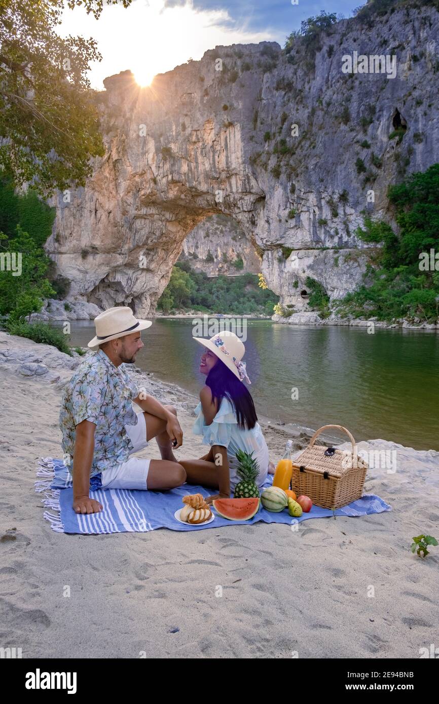 couple men and woman visiting The famous natural bridge of Pont d'Arc ...