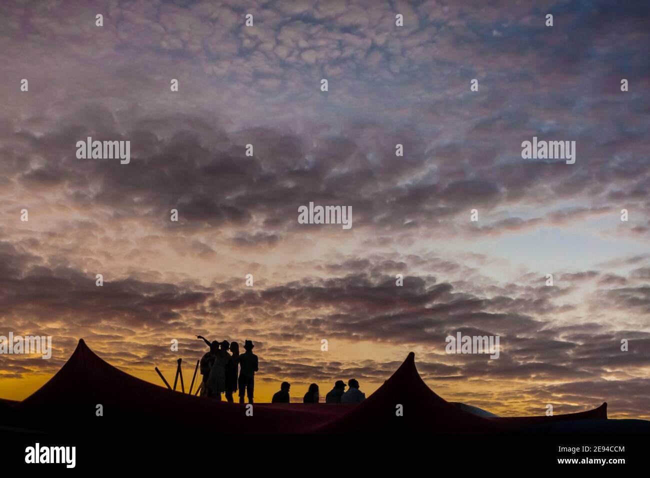 Group of people looking at the beautiful sunset captured in South ...