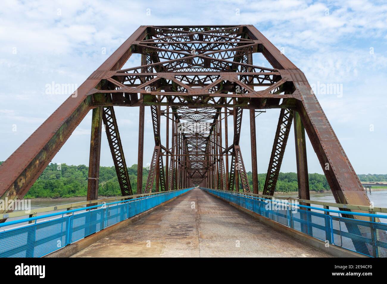 Beautiful view of road and truss bridge above water and the forest in ...