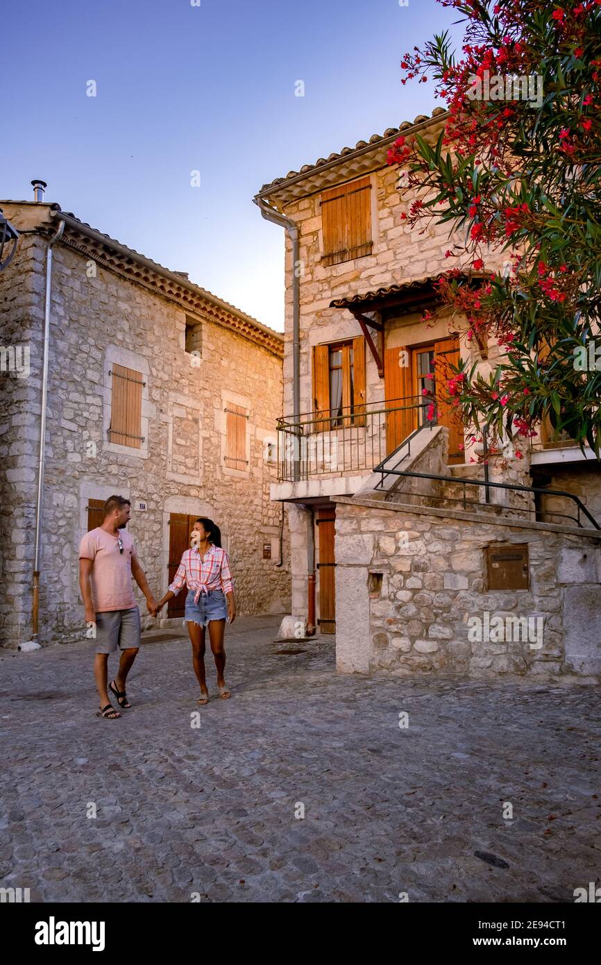 couple visit Ruoms, The medieval village of Ruoms with its old brick ...