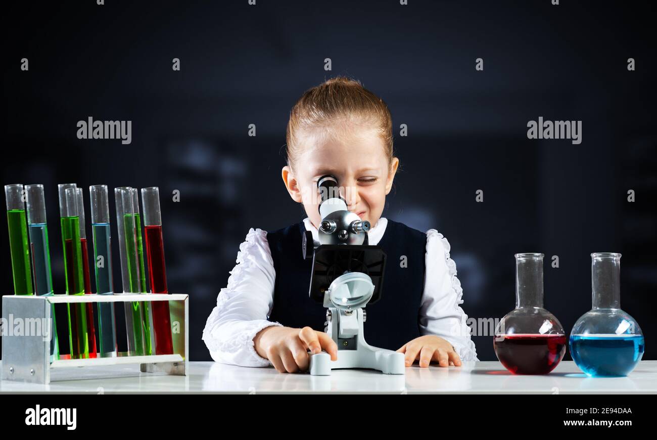 Little scientist looking through microscope Stock Photo - Alamy